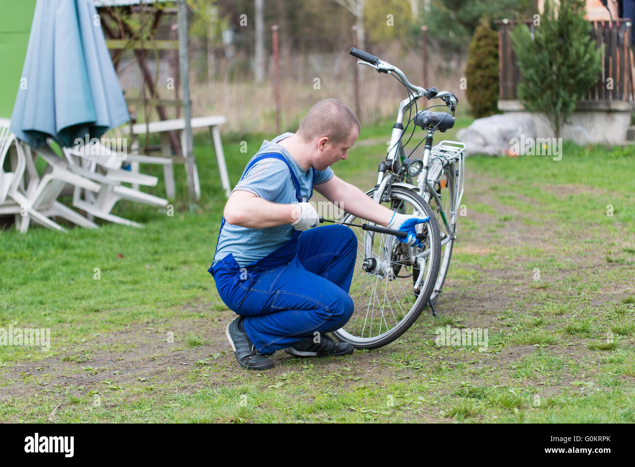 Man pumping wheel bike. preparation for the bike season Stock Photo - Alamy