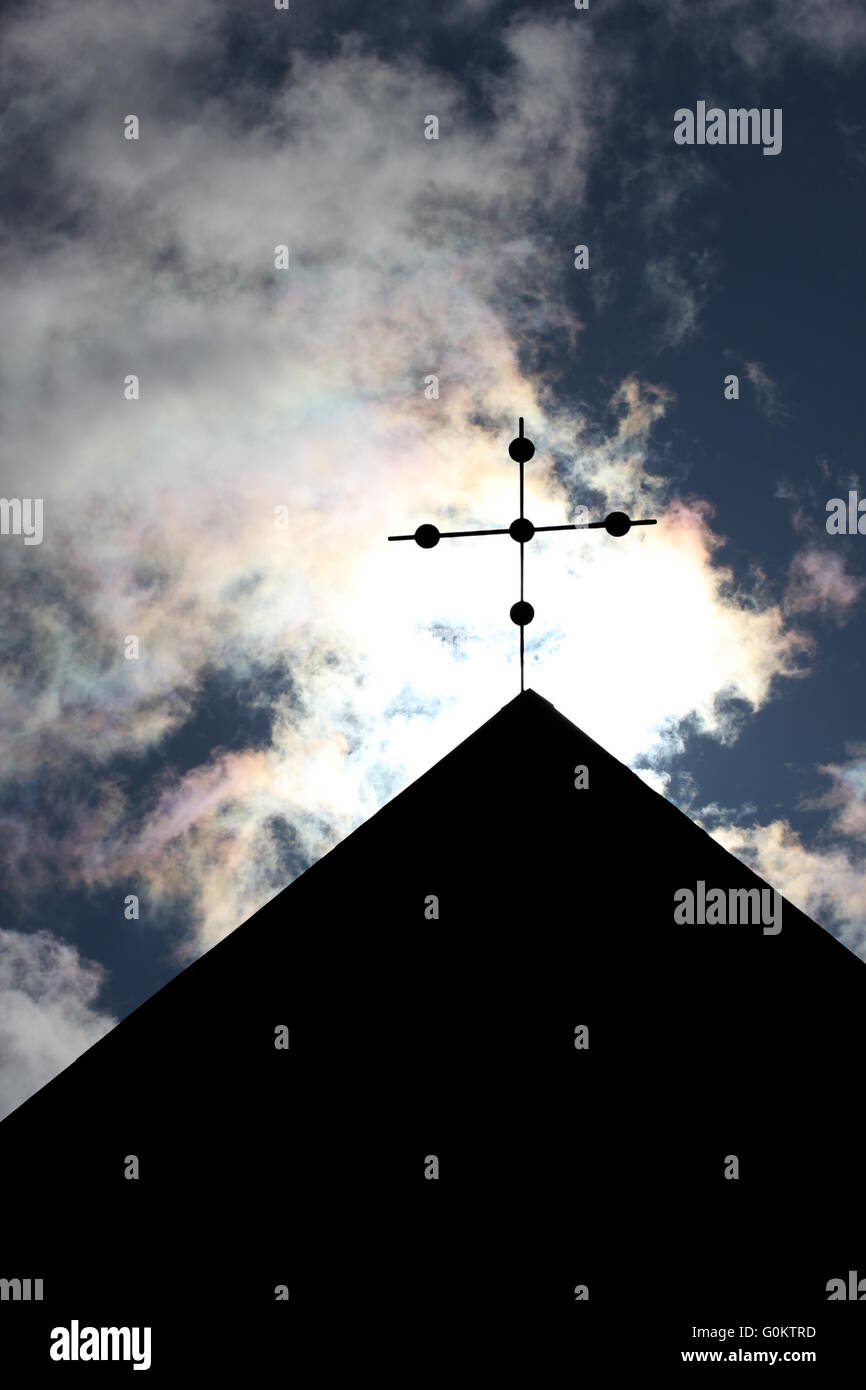 Cross on a church in front of bright sunlight Stock Photo - Alamy