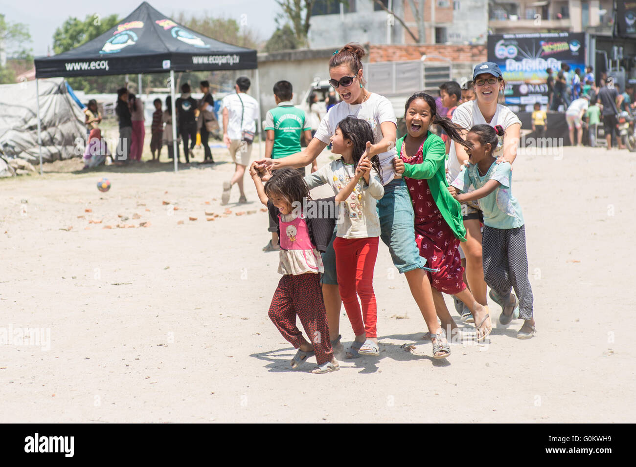 Children playing with volunteers at a camp set up for families that ...