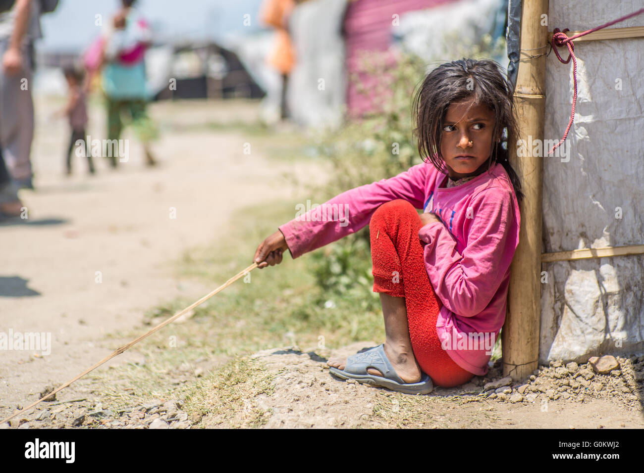 A child sitting down during a "kids play day" at a camp for families ...