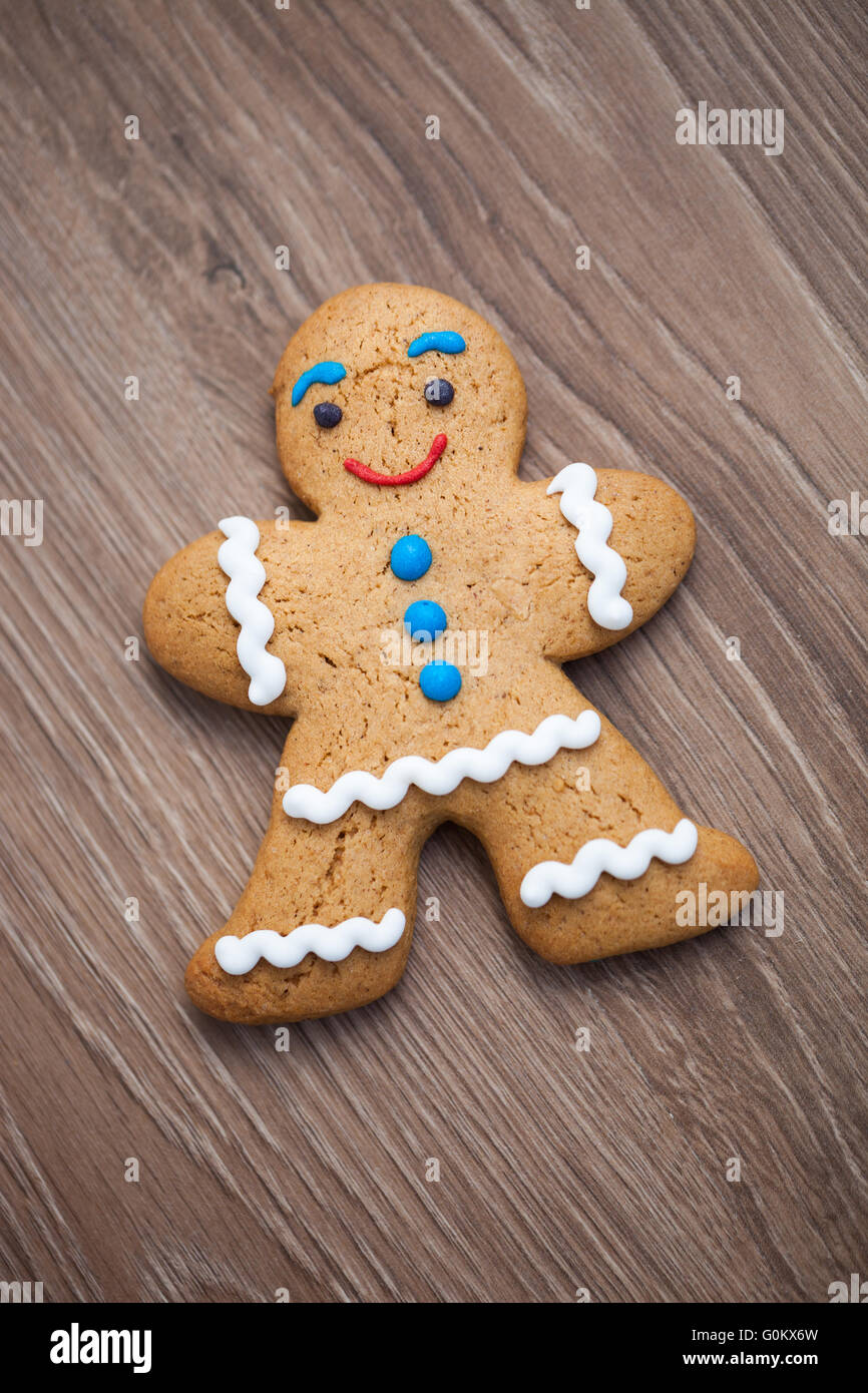 Funny smiling gingerbread man on wooden table. Smiling eatable ...
