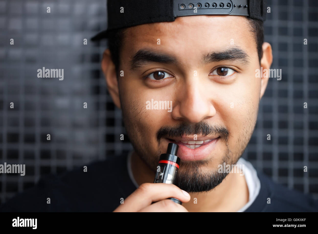 Young african man smoking e cigarette hi-res stock photography and ...