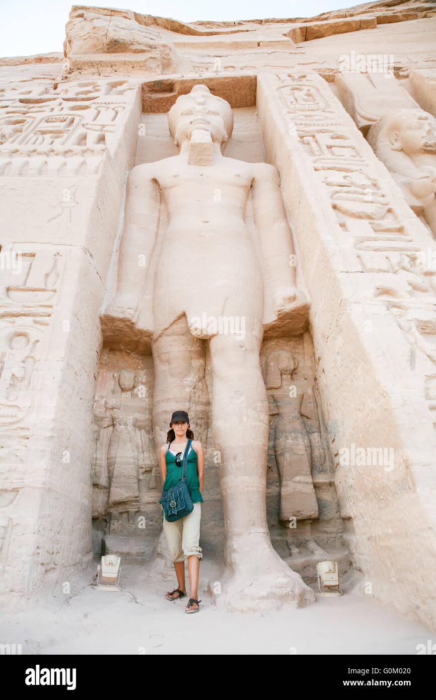 tourist woman standing down giant Ramses sculpture in facade of famous ...