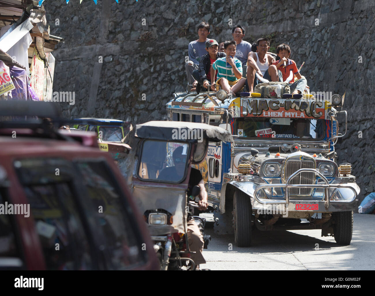 People sit on top of a Jeepney in the Cordilleras town of Banaue ...