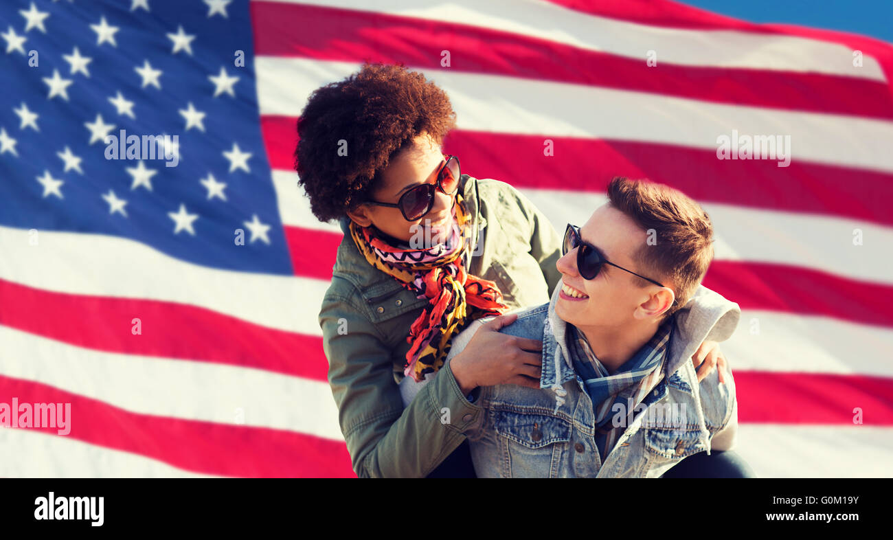 happy multiracial couple over american flag Stock Photo - Alamy