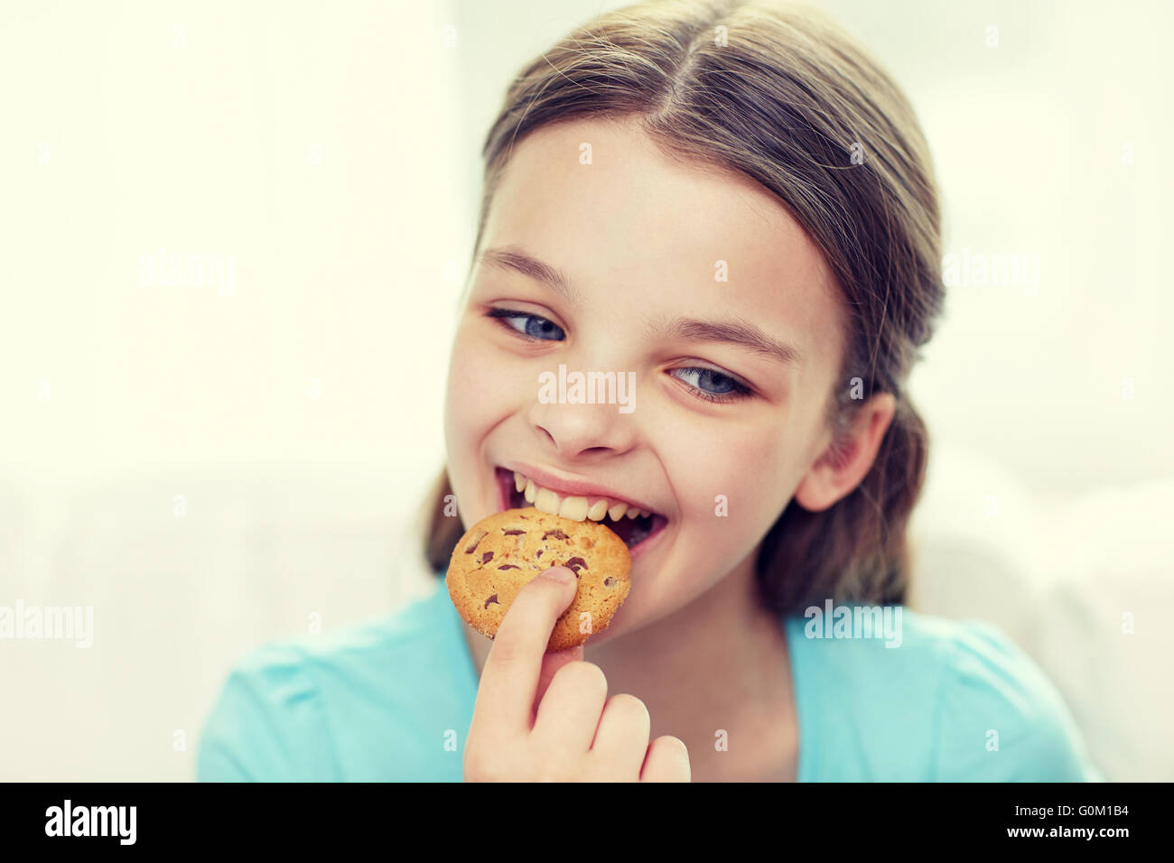 Little girl eating cookie hi-res stock photography and images - Alamy
