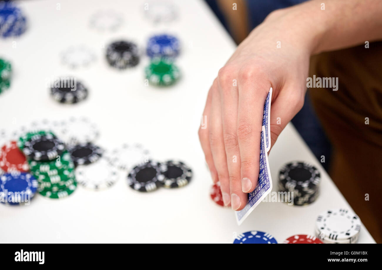 close up of male hand with playing cards and chips Stock Photo - Alamy