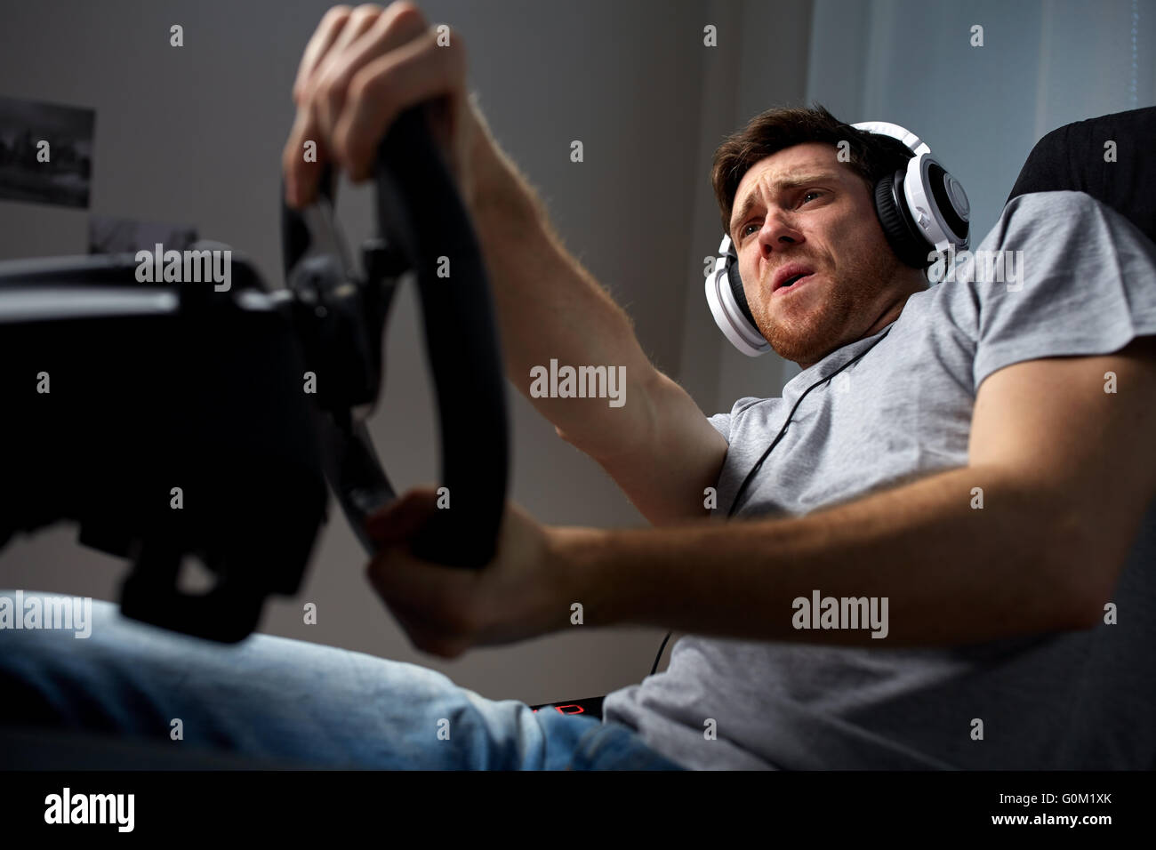 man playing car racing video game at home Stock Photo - Alamy