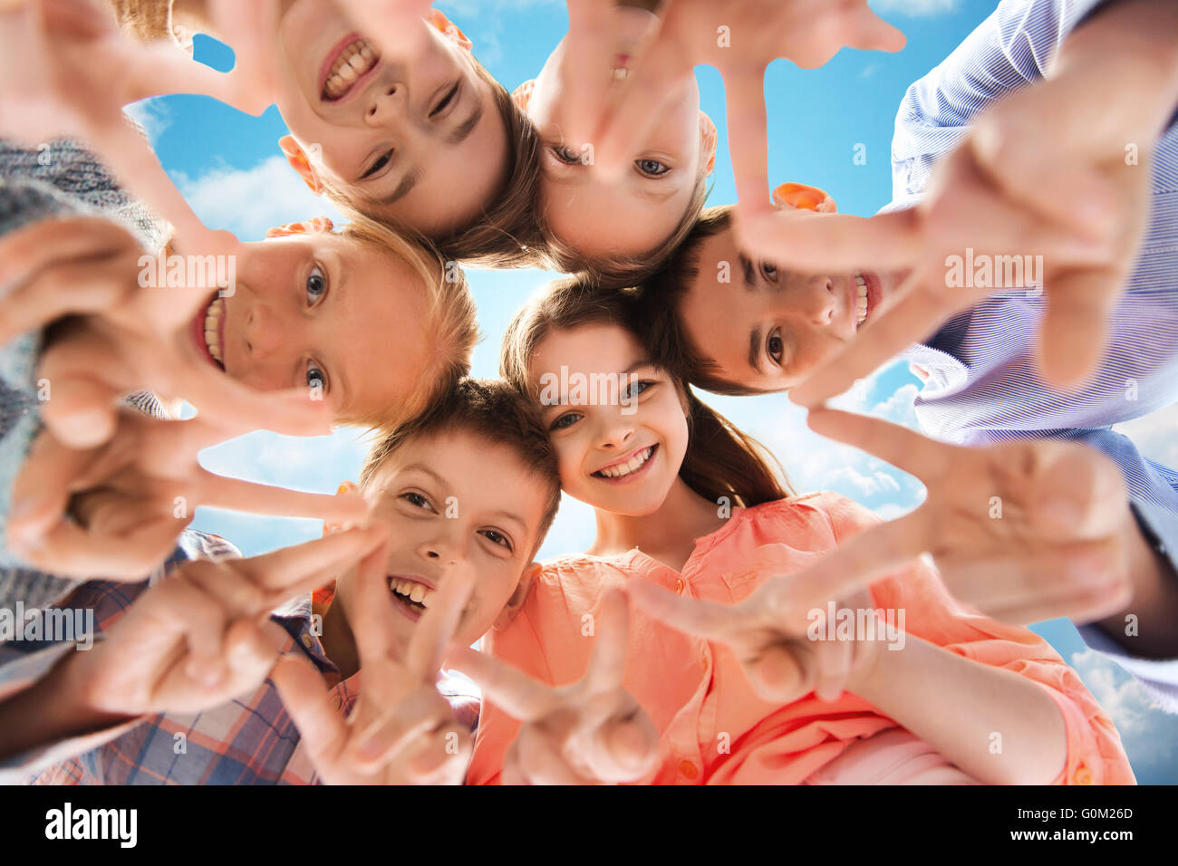 happy children showing peace hand sign Stock Photo - Alamy