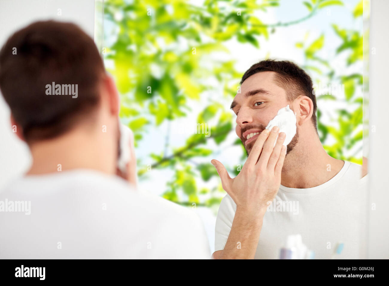happy man applying shaving foam at bathroom mirror Stock Photo - Alamy