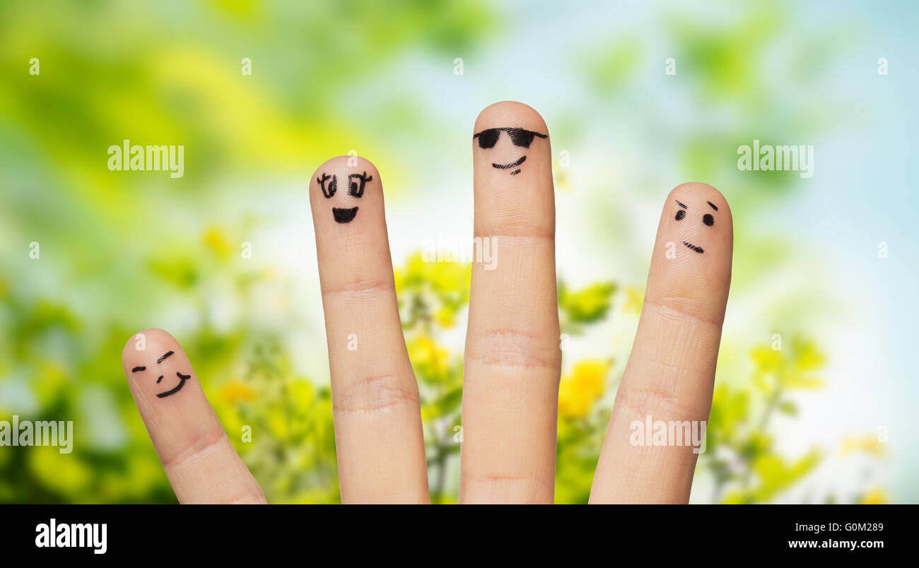 close up of fingers with smiley faces over nature Stock Photo - Alamy