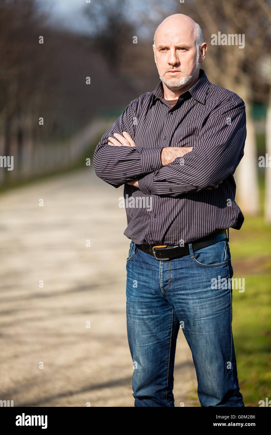 Confident attractive man standing waiting Stock Photo - Alamy