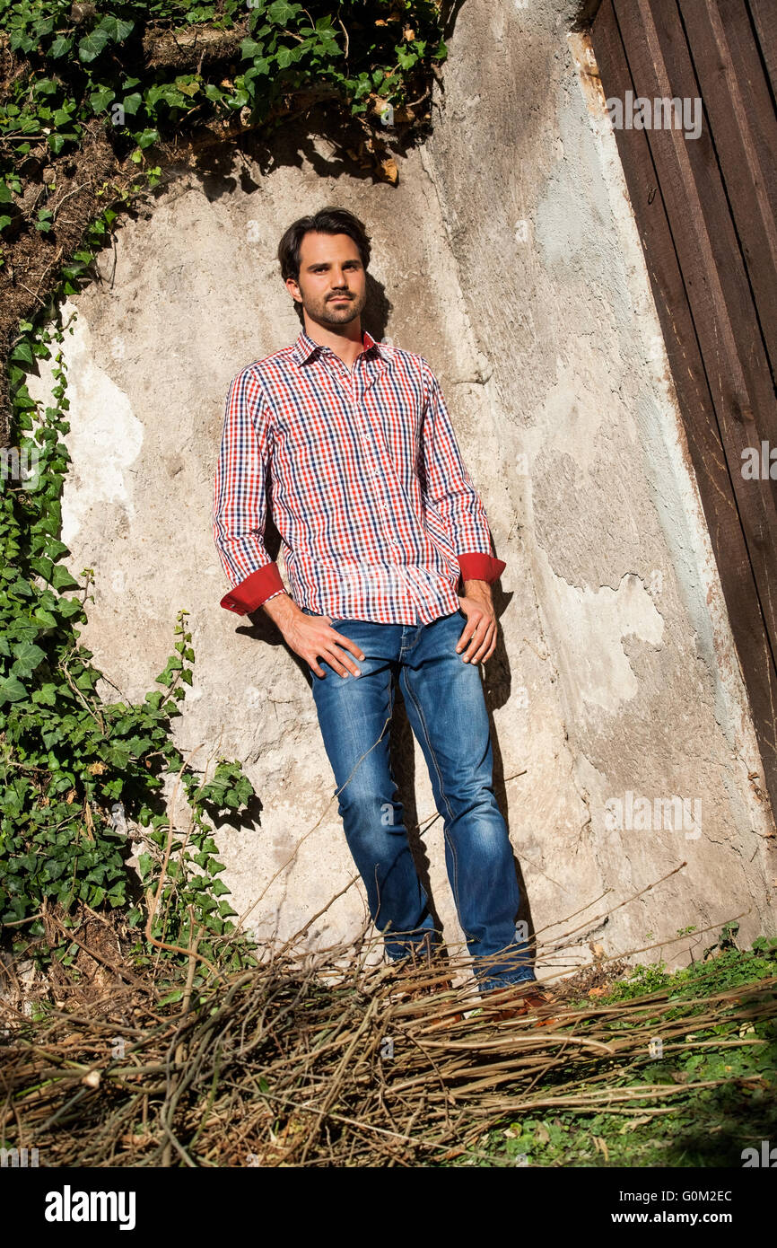 Male model sitting with legs crossed Stock Photo - Alamy