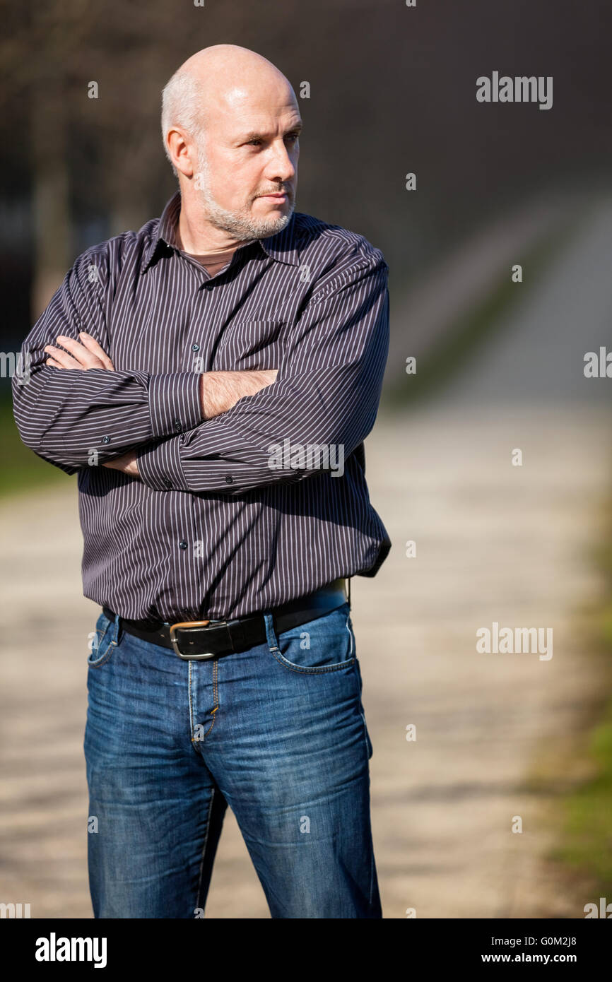 Confident attractive man standing waiting Stock Photo - Alamy