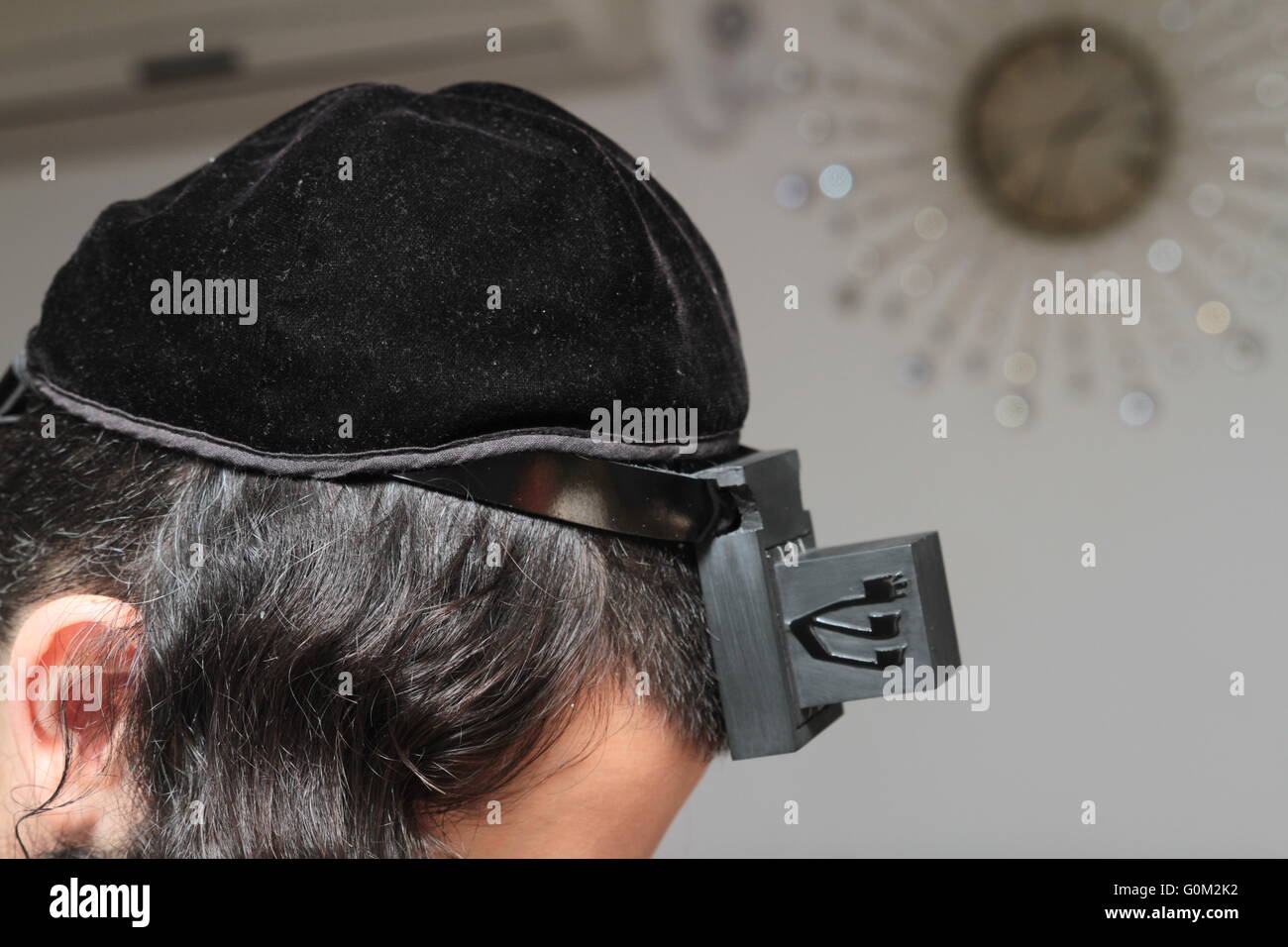 Jewish Man wrapped in tefillin pray . A religious orthodox Jew with arm ...
