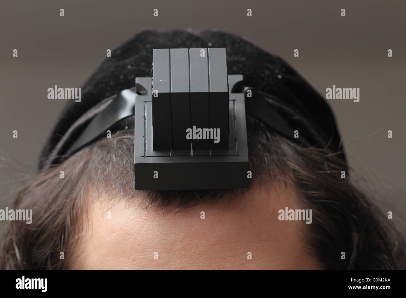 Jewish Man wrapped in tefillin pray . A religious orthodox Jew with arm ...