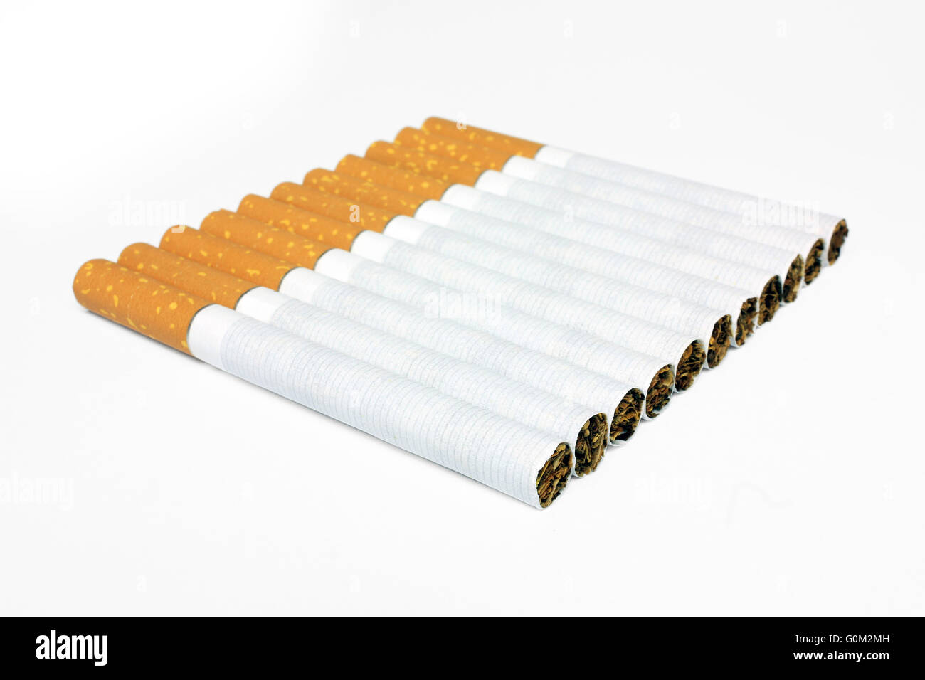 Cigarettes in line isolated on white background Stock Photo - Alamy