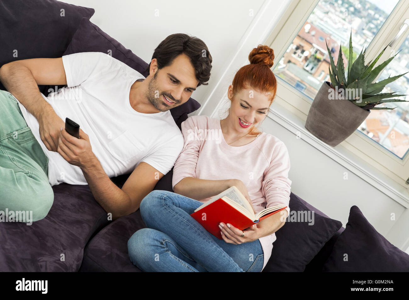Couple Resting on the Sofa at the Living Room Stock Photo - Alamy