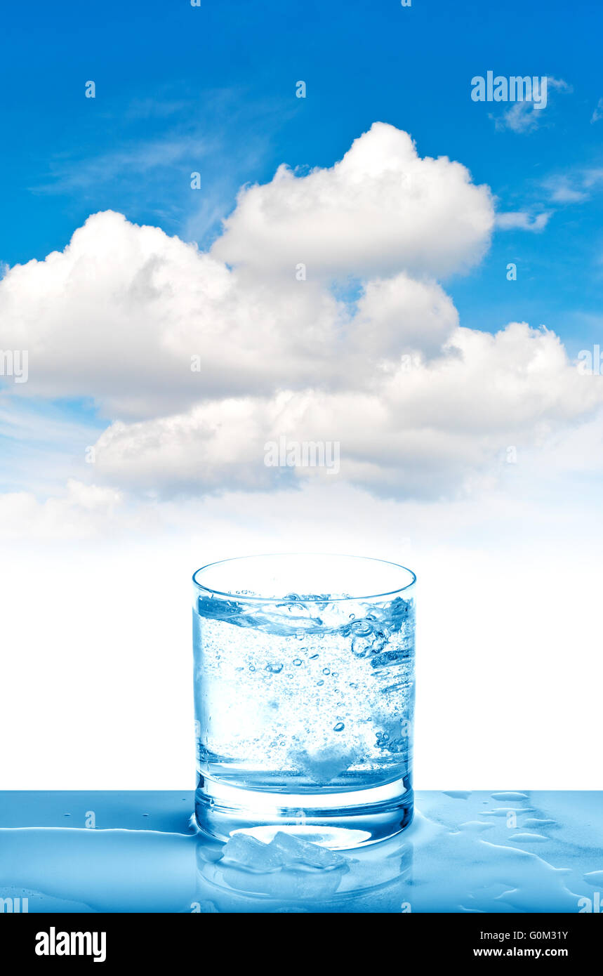 Sparkling water in glass on blue sky background. Fresh cold drink Stock ...
