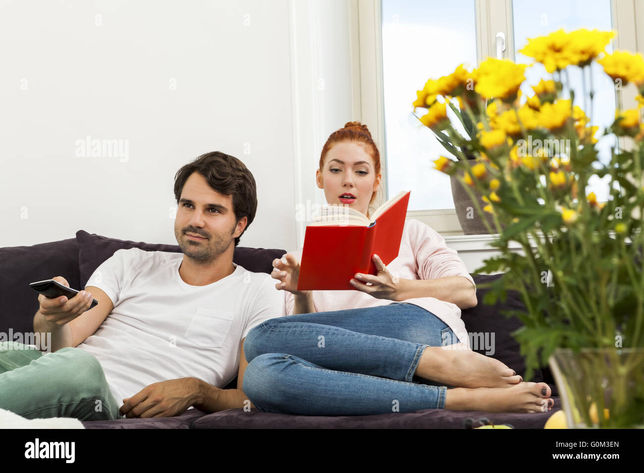 Couple Resting on the Sofa at the Living Room Stock Photo - Alamy