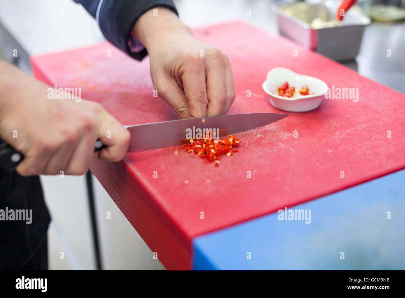 Chef dicing red hot chili peppers Stock Photo - Alamy