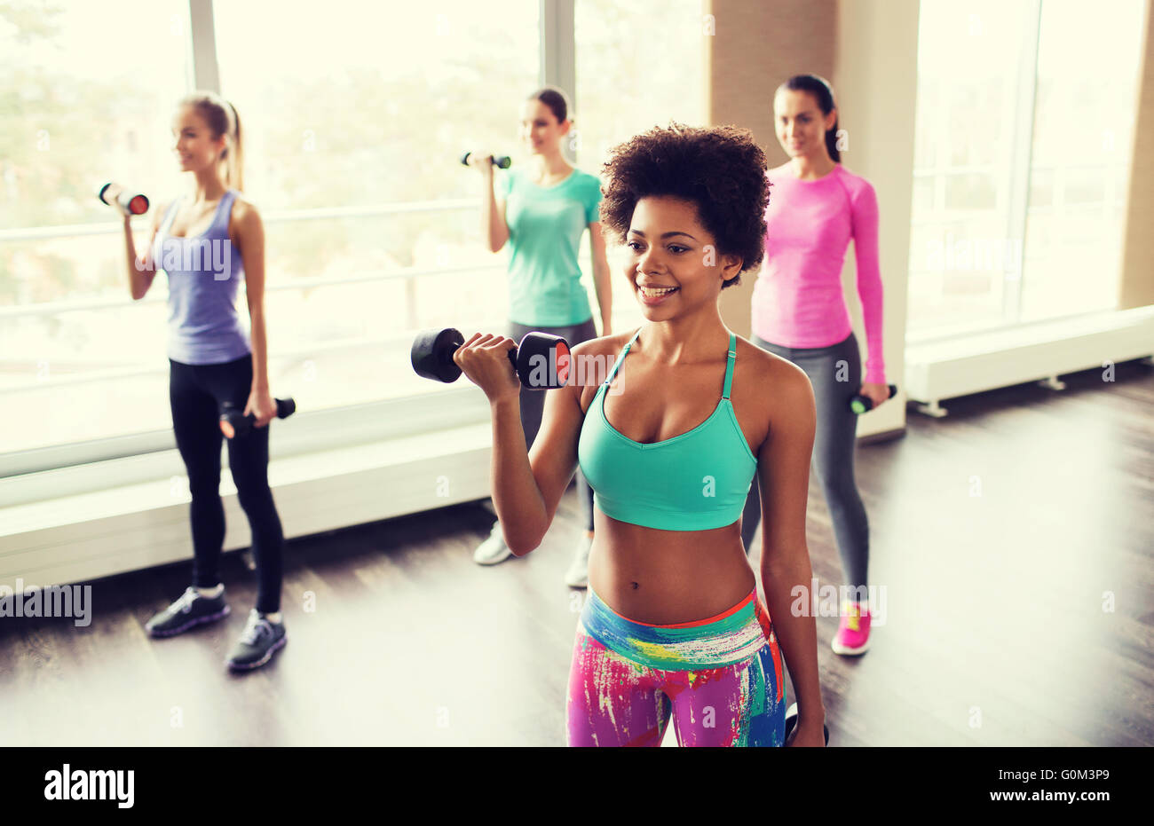 group of happy women with dumbbells in gym Stock Photo - Alamy