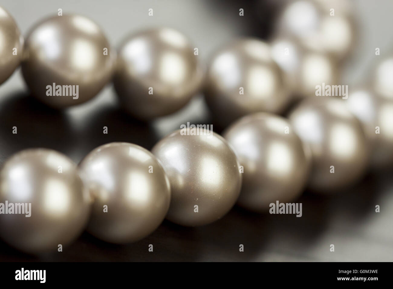 String of shiny grey beads Stock Photo - Alamy