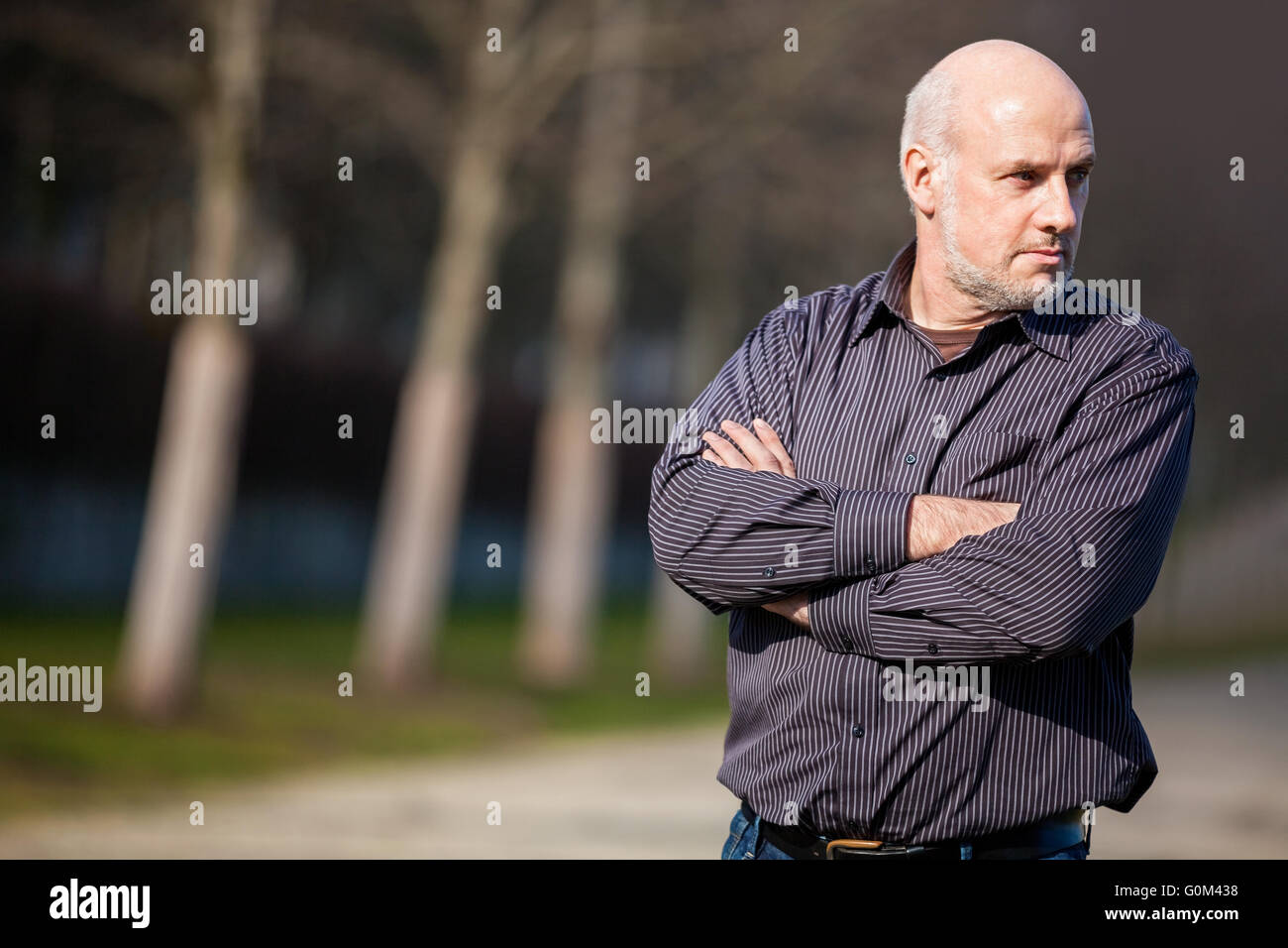 Confident attractive man standing waiting Stock Photo - Alamy