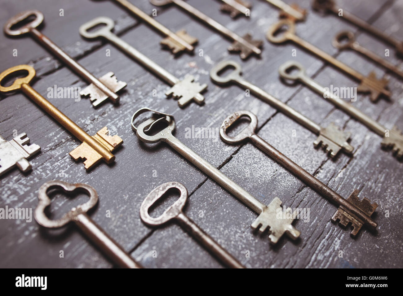 Some door keys aligned on old wooden surface, safety and security ...