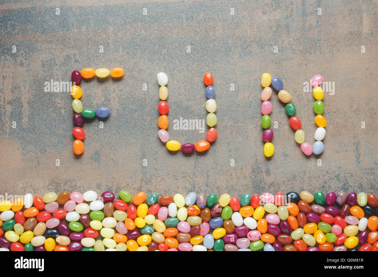 Word fun written with jelly beans, dark background with colorful border ...