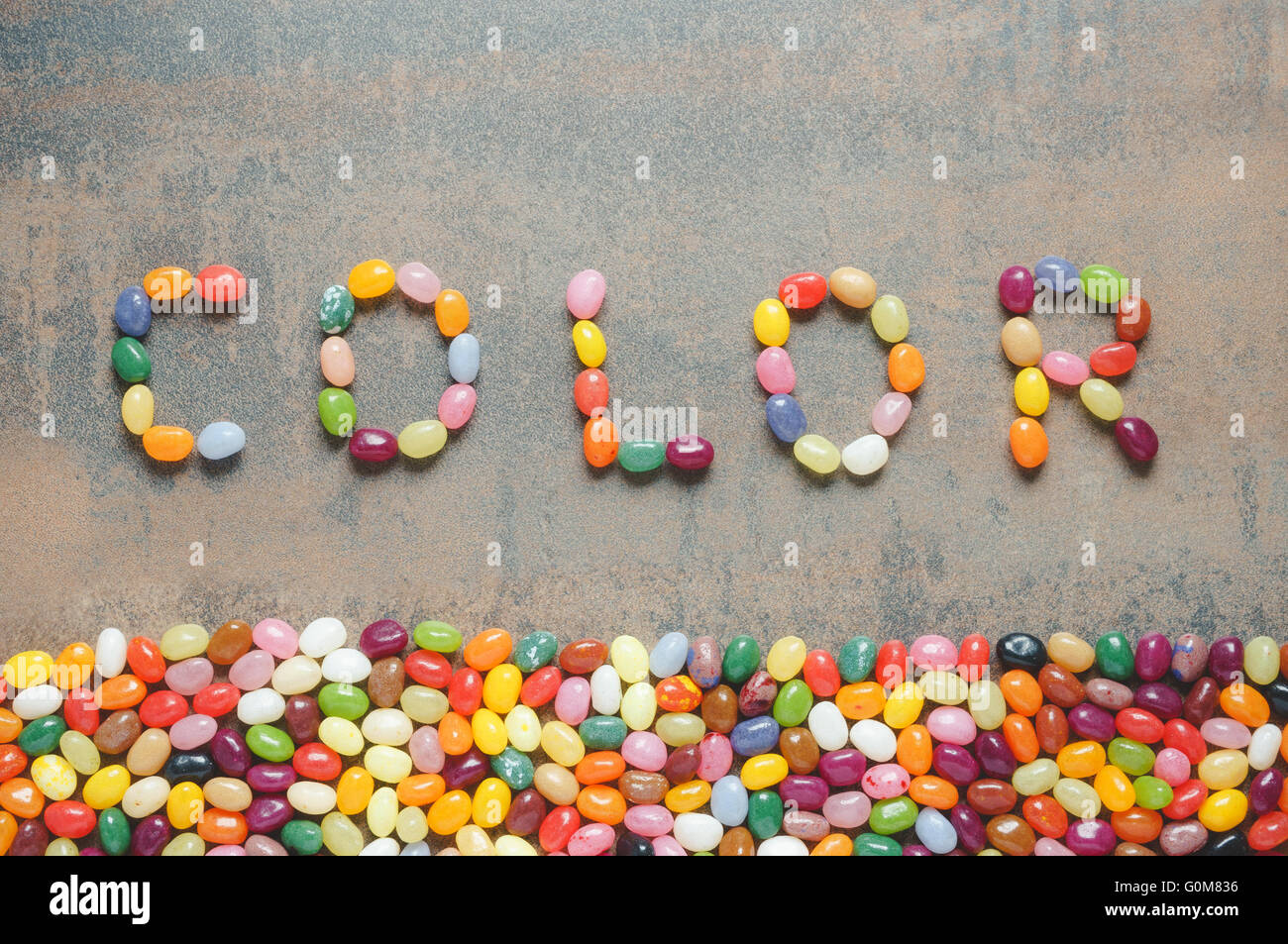 Word color written with jelly beans, dark background with colorful ...