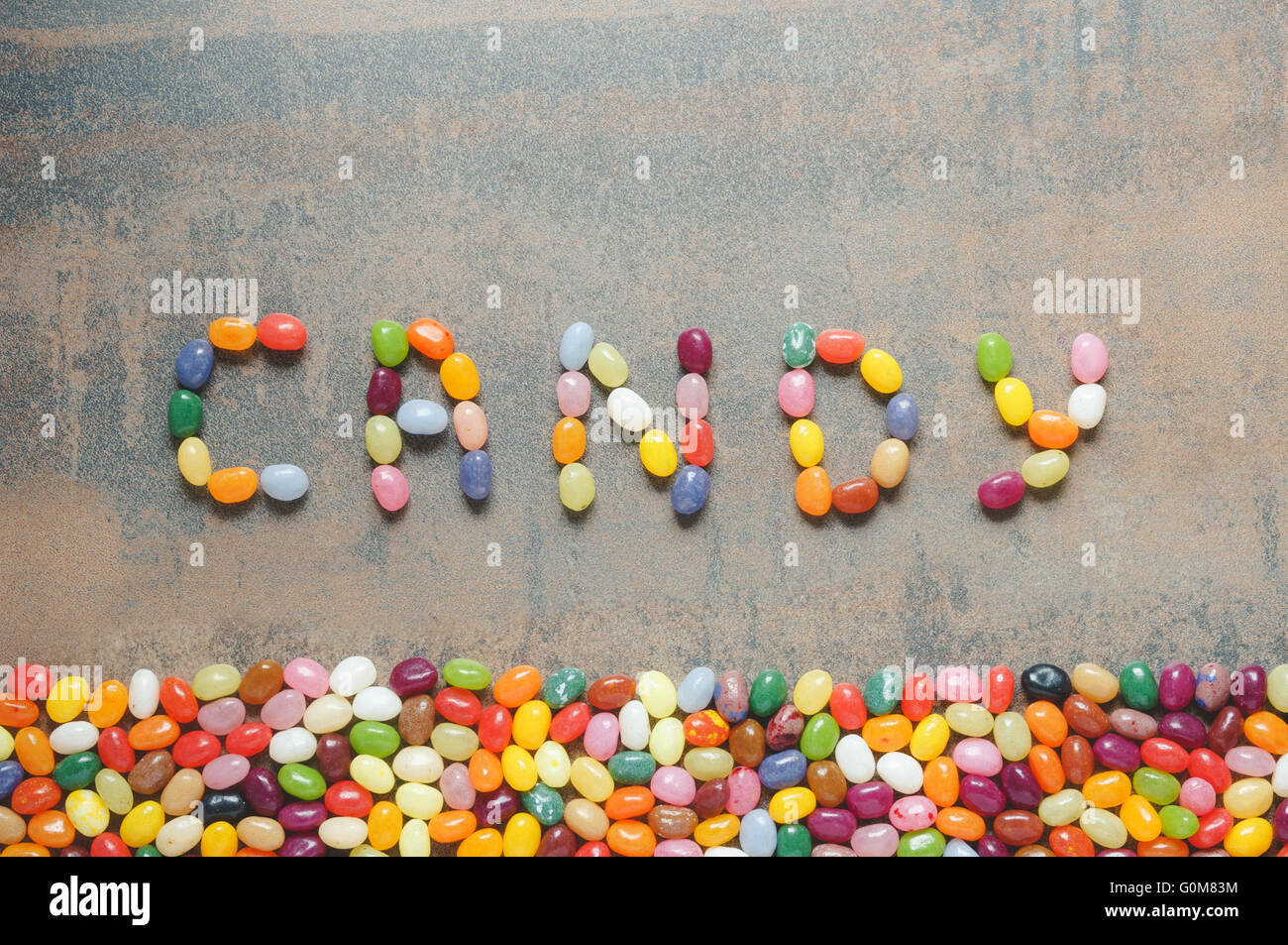 Word candy written with jelly beans, dark background with colorful ...