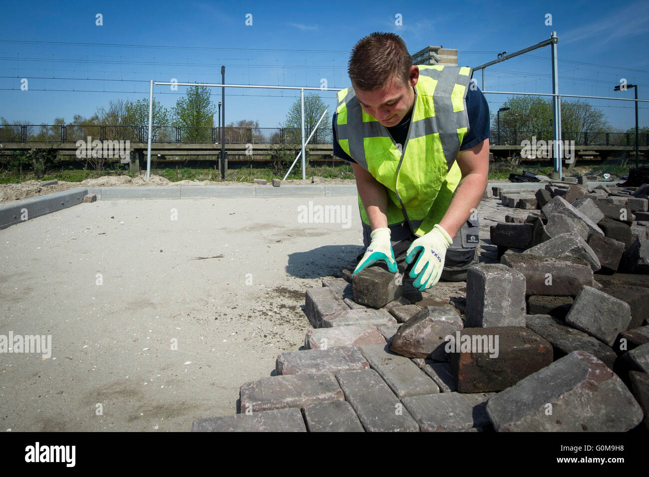 Young man paving a street Stock Photo - Alamy