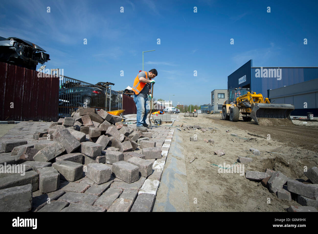 Men working on infrastructure. Paving the street Stock Photo - Alamy
