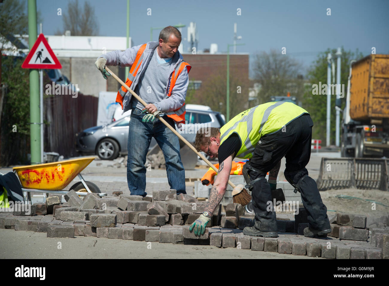 Men working on infrastructure, paving a street Stock Photo - Alamy