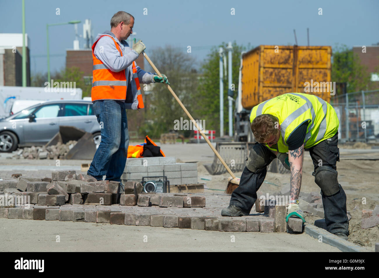 Men working on infrastructure, paving a street Stock Photo - Alamy