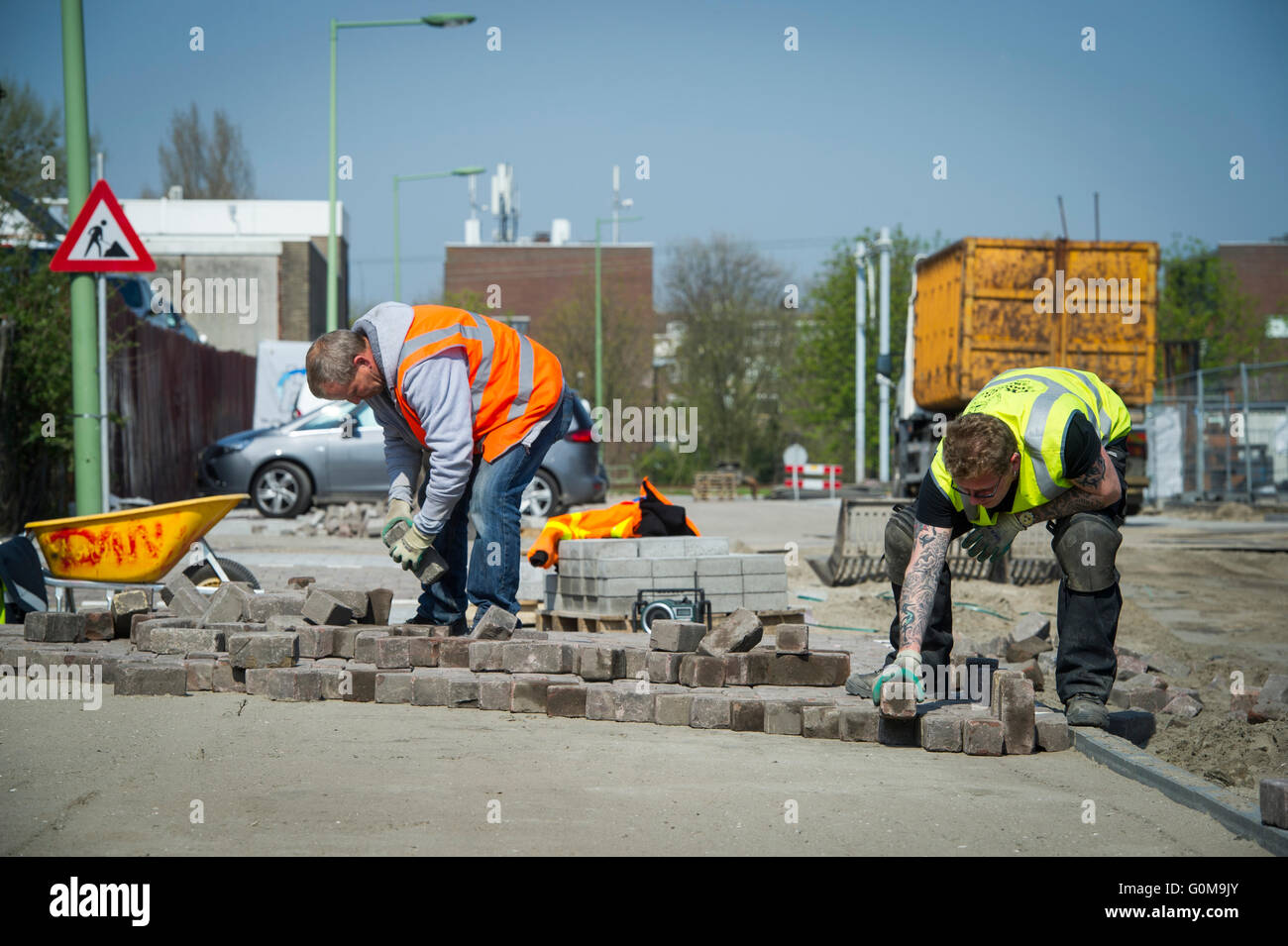Men working on infrastructure, paving a street Stock Photo - Alamy