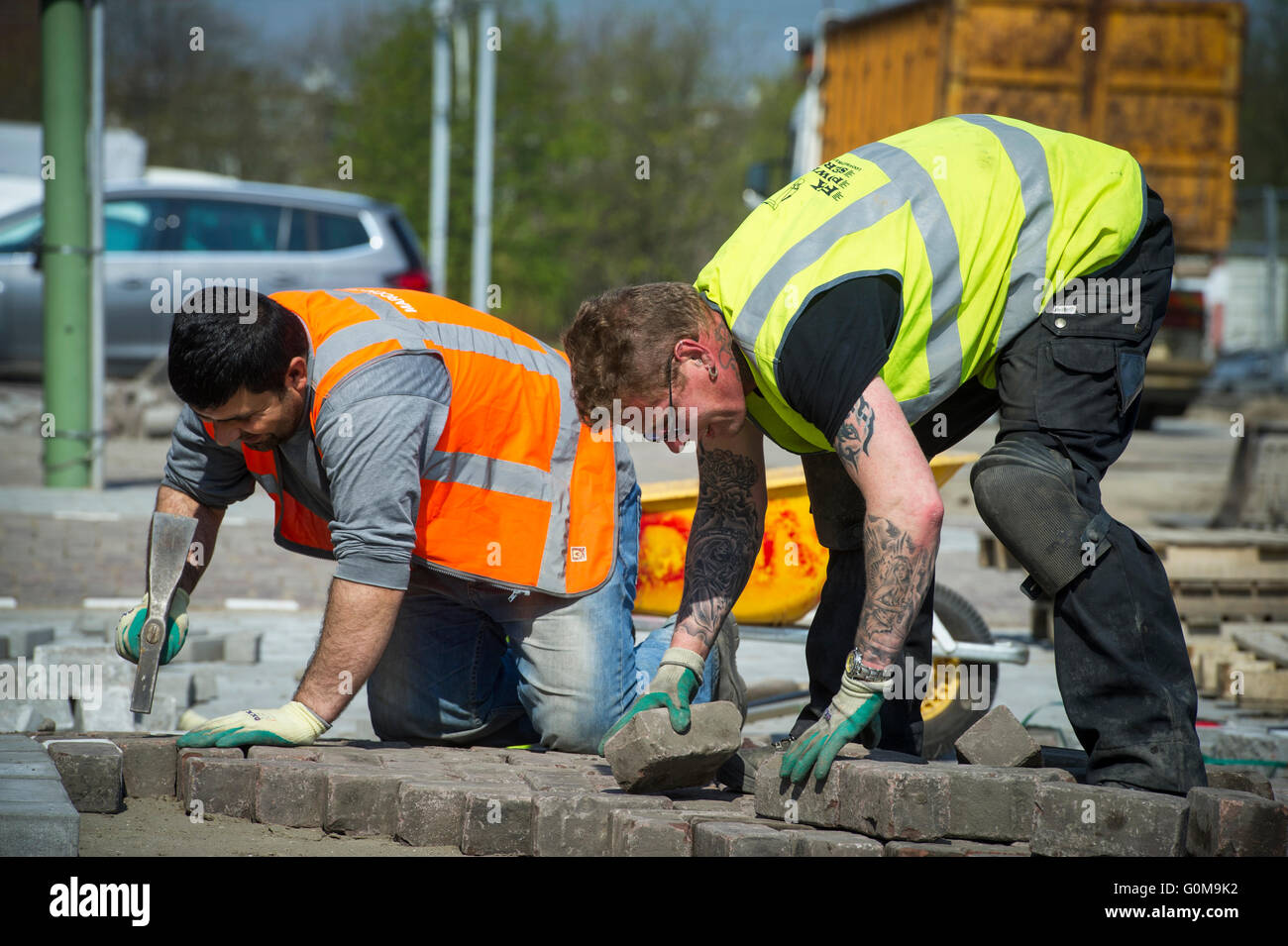 Men working on infrastructure, paving the street Stock Photo - Alamy