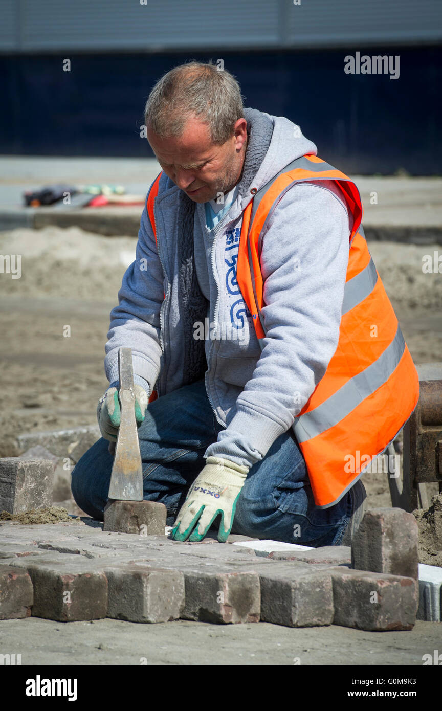A man paving a street Stock Photo - Alamy