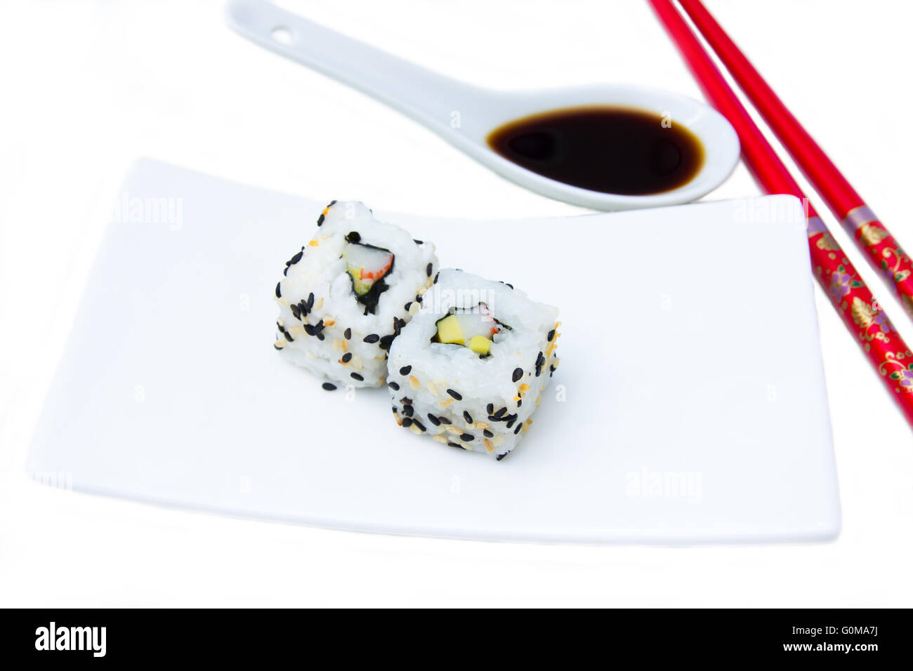 California roll with avocado and surimi on a white background seen up ...