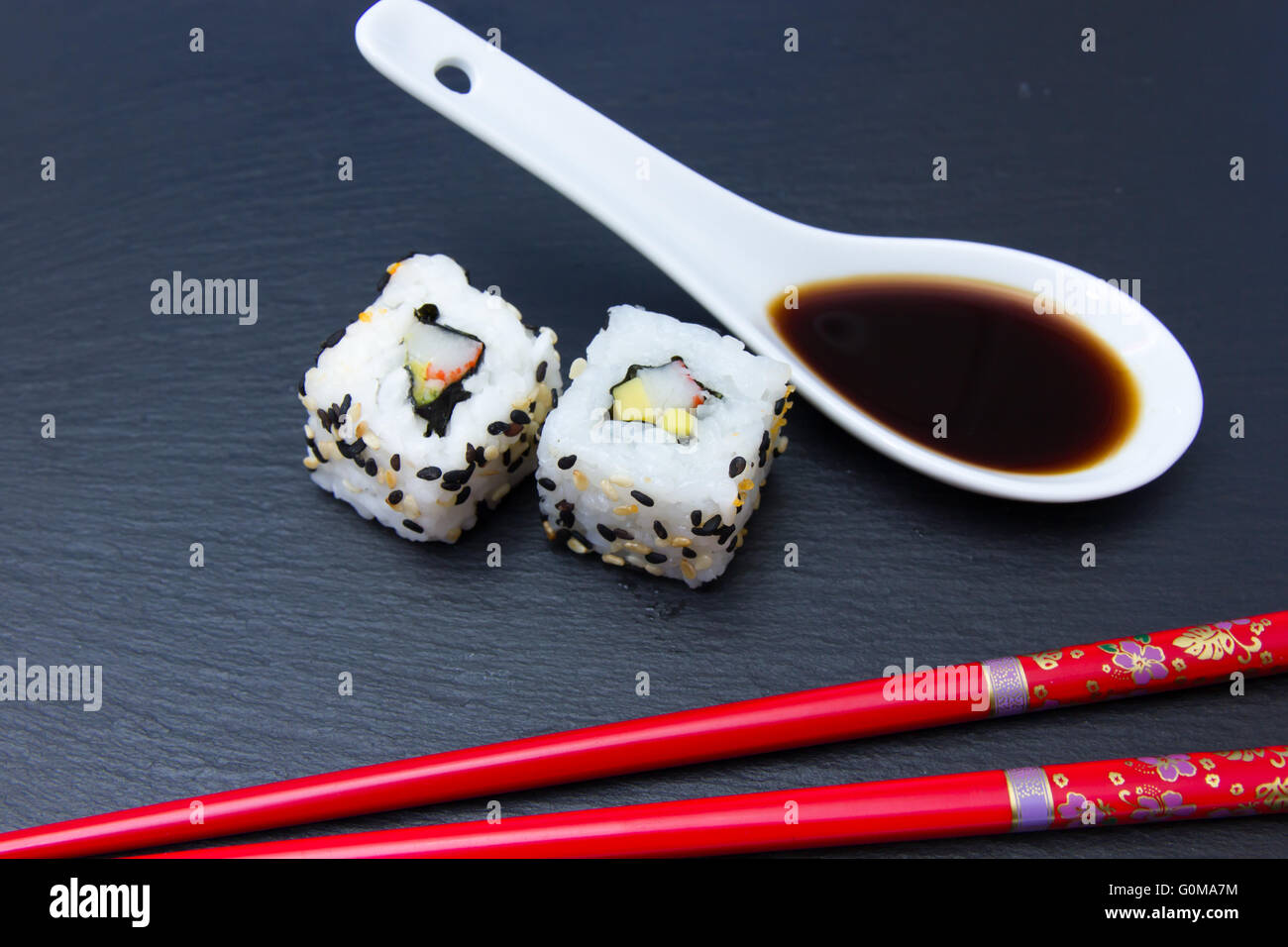 California roll with avocado and surimi on slate floor seen up close ...