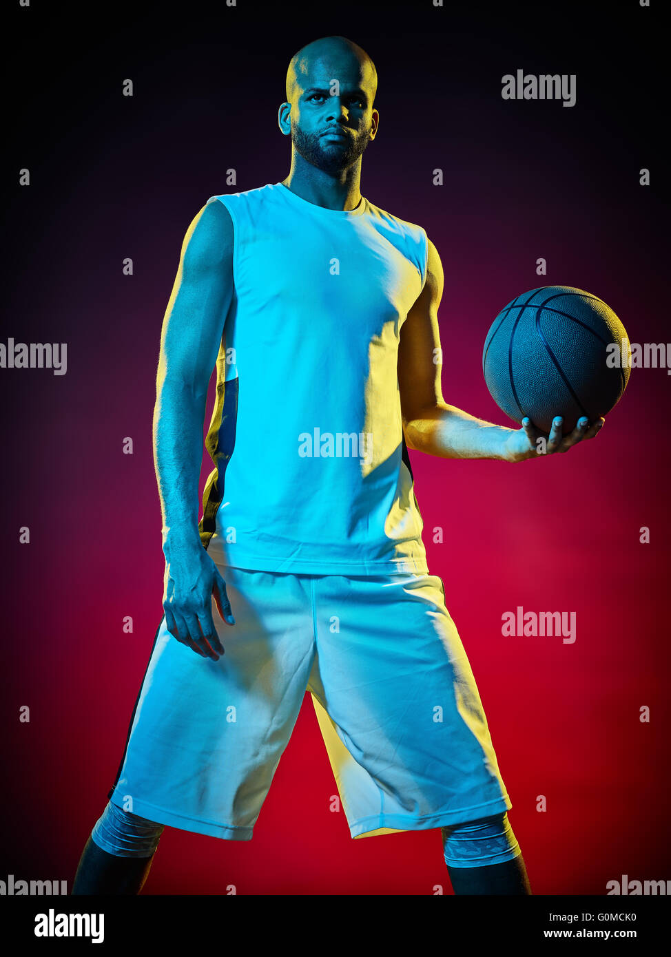 one basketball player man Isolated on black background Stock Photo - Alamy