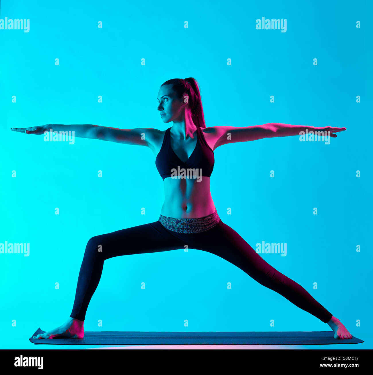 one caucasian woman exercising Virabhadrasana warrior position yoga ...