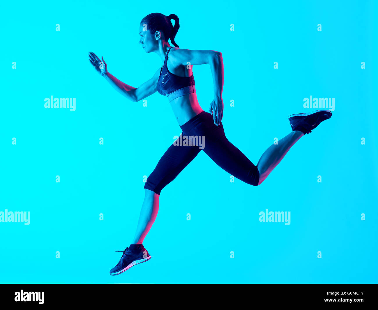 one mixed races woman runner running isolated on blue blackground Stock ...