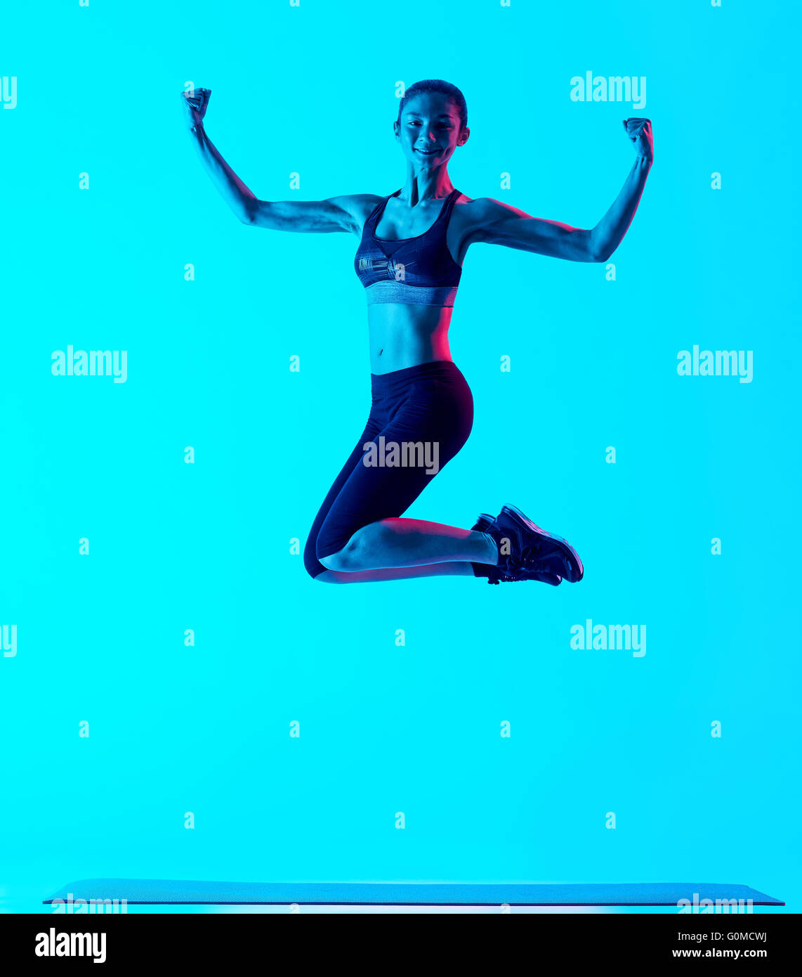 one mixed races woman exercsing fitness exercices jumping happy ...