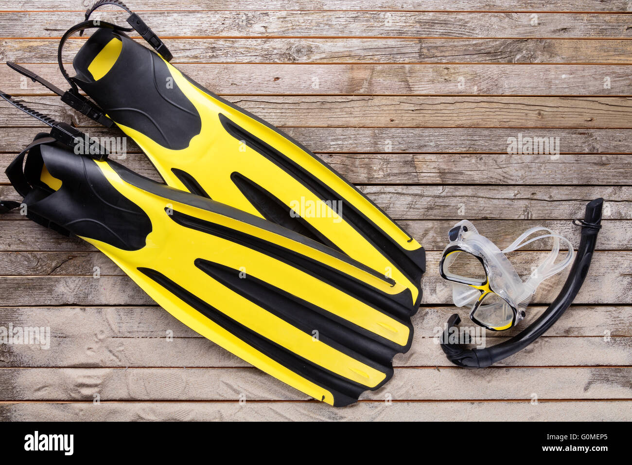 Mask, fins and snorkel on wooden desk. Equipment for diving Stock Photo ...