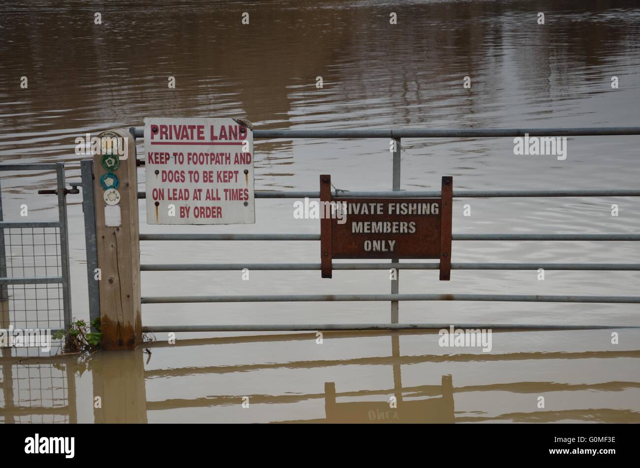 Gate with Signs in Flooded River Stock Photo - Alamy