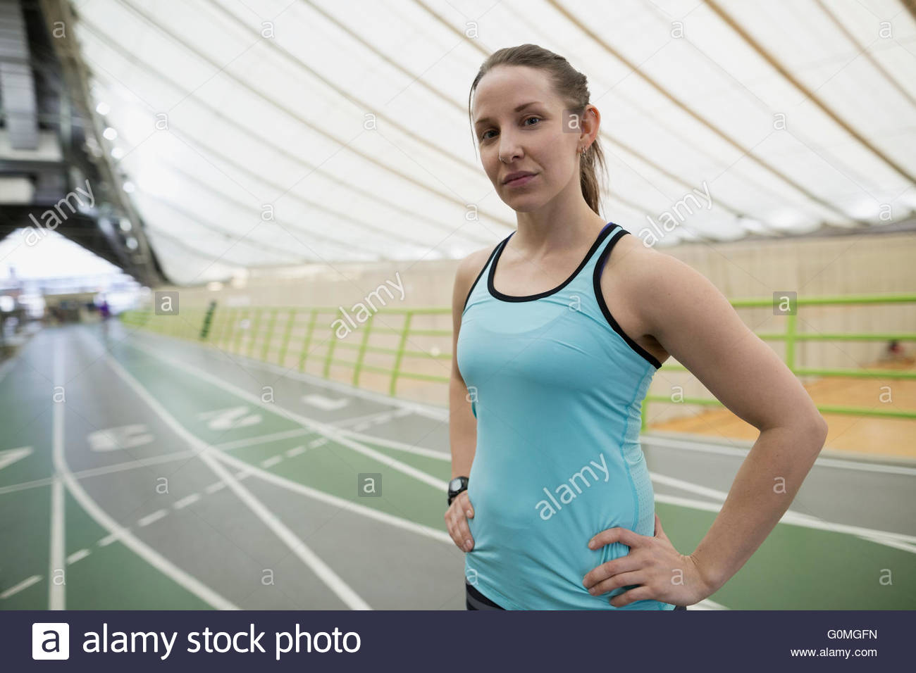 Portrait confident female runner on indoor track Stock Photo - Alamy
