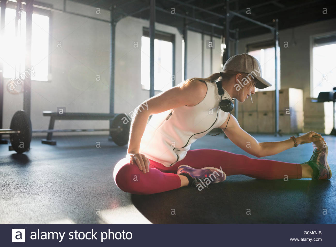 Woman stretching leg at gym Stock Photo - Alamy