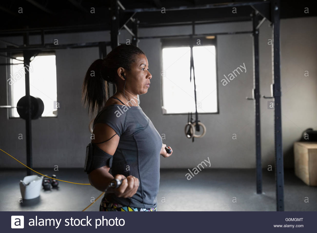 Focused woman jumping rope at gym Stock Photo - Alamy